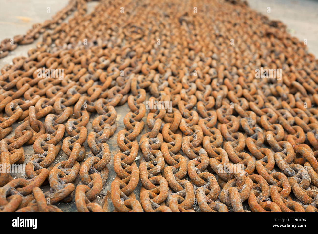 a lot of rusty metal chains lie on the deck of the ship Stock Photo - Alamy