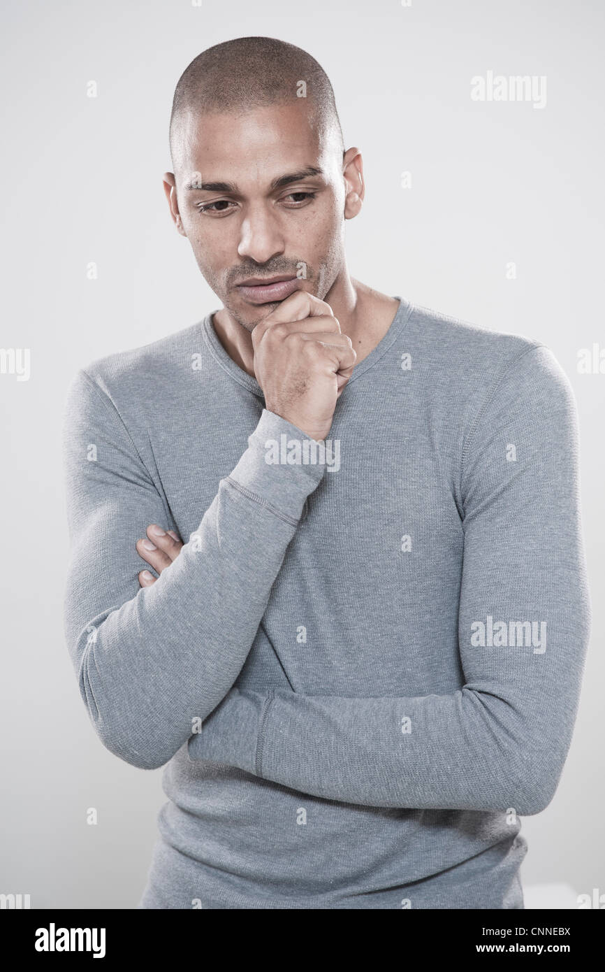 Man touching unshaven face in hi-res stock photography and images - Alamy