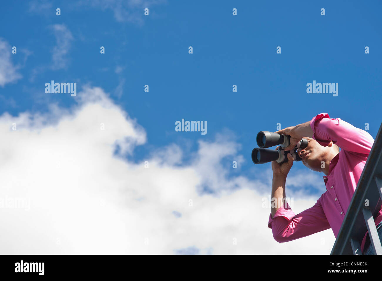 Man Looking through Binoculars Stock Photo - Alamy