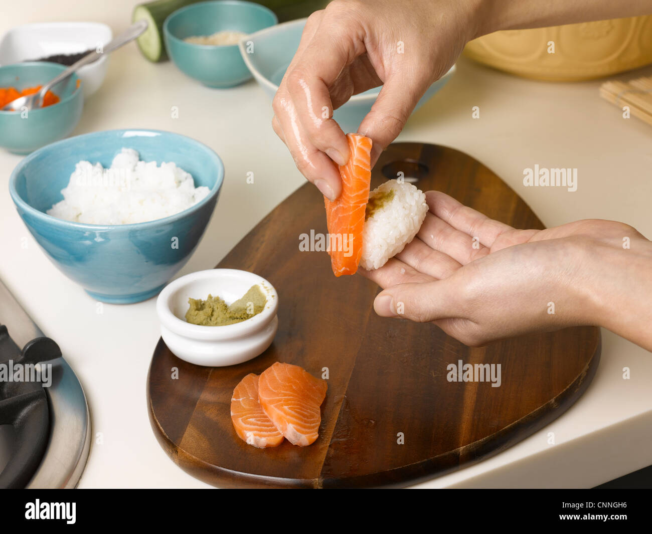 Woman preparing sushi at table Stock Photo - Alamy