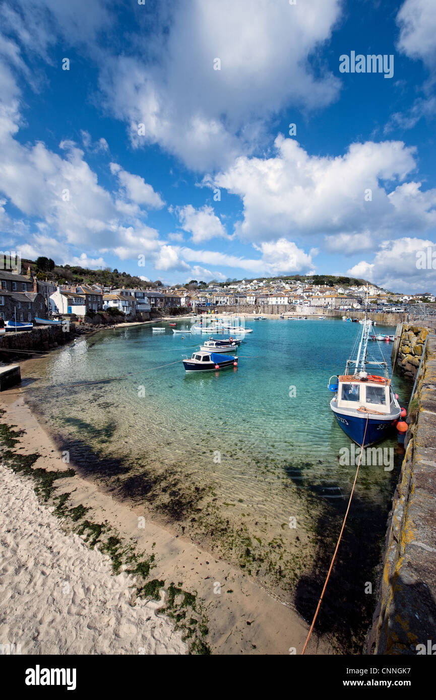 A view of the tourist attraction, Mousehole harbor with fishing boats ...