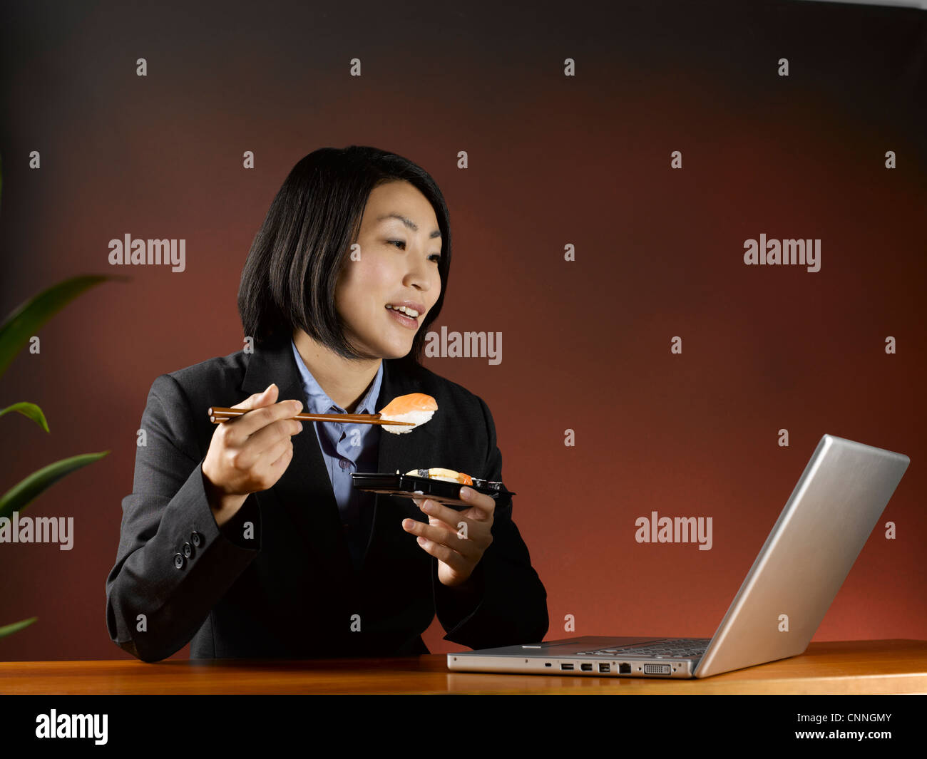Woman eating sushi office desk hi-res stock photography and images - Alamy