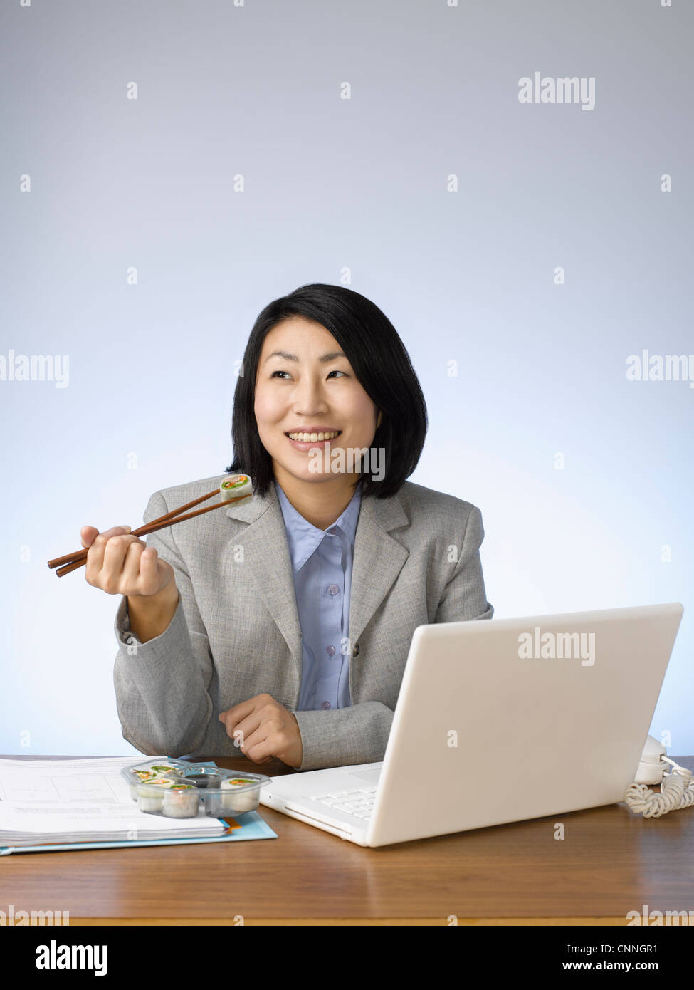 Woman eating sushi office desk hi-res stock photography and images - Alamy