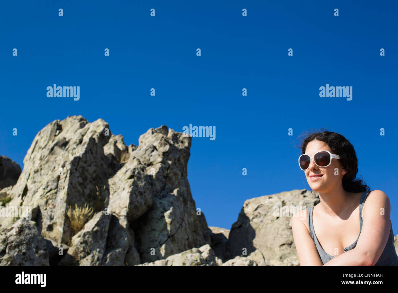 Lady sitting on rocks hi-res stock photography and images - Alamy