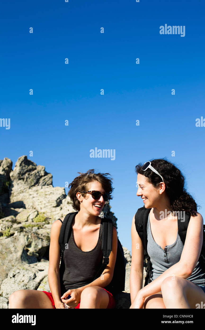 Hikers resting on rocks Stock Photo - Alamy