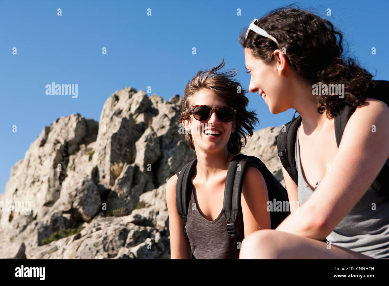 Hikers resting on rocks Stock Photo - Alamy