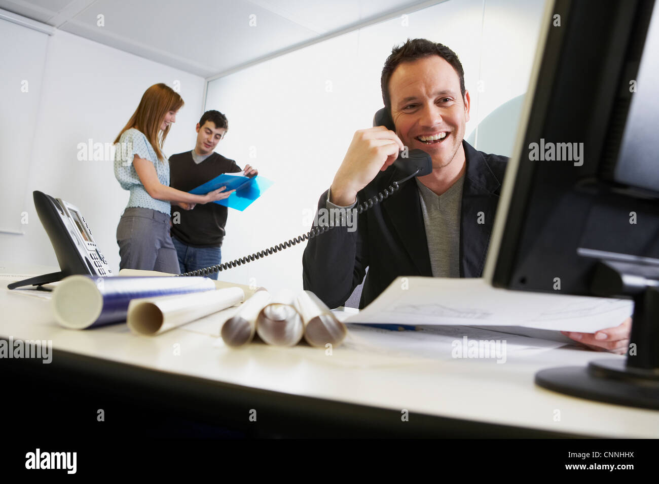 Businessman talking on phone at work Stock Photo - Alamy