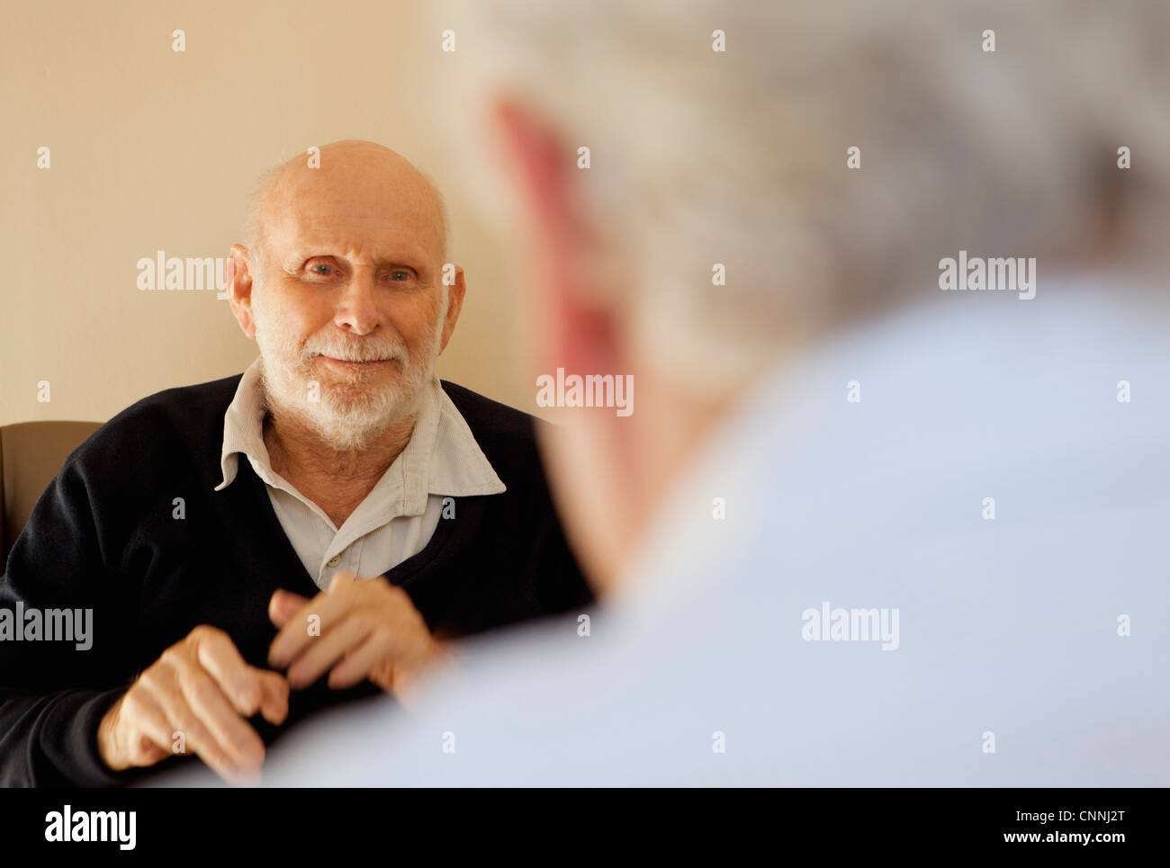 Older men talking indoors Stock Photo - Alamy