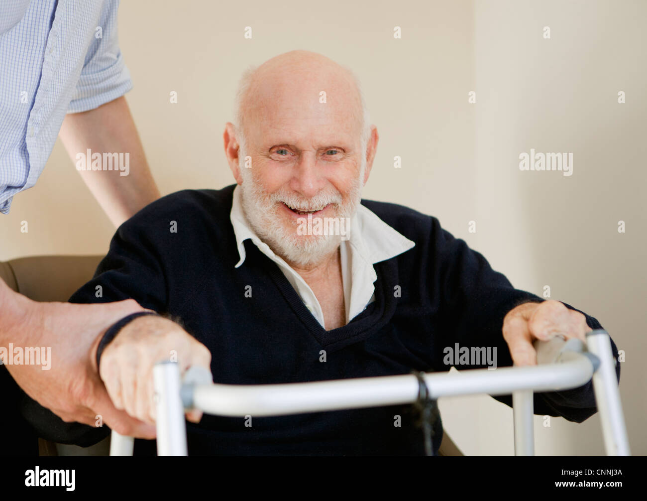 Smiling older man using walker Stock Photo - Alamy