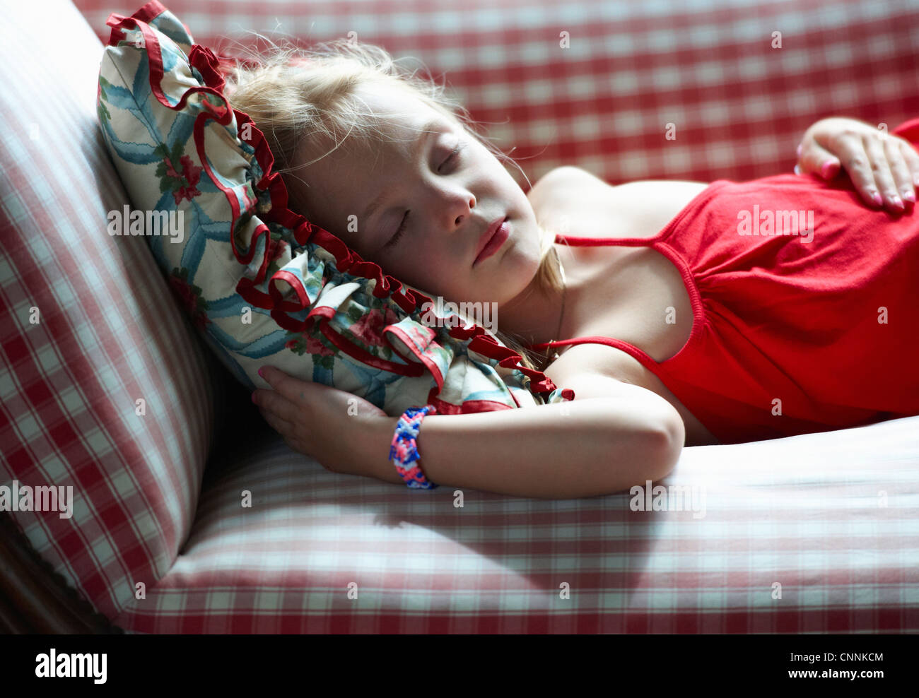 Girl napping on couch Stock Photo - Alamy