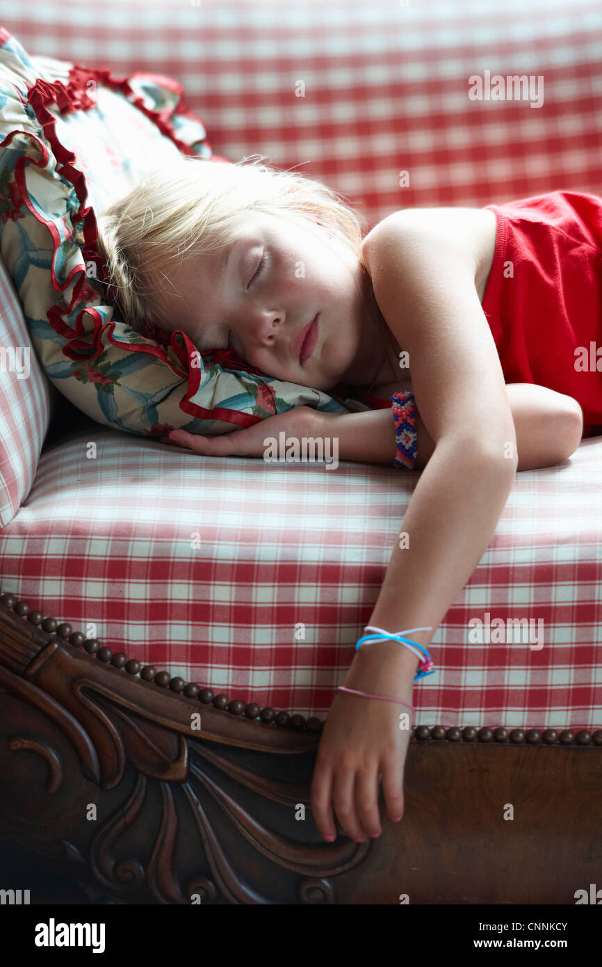Girl napping on couch Stock Photo - Alamy