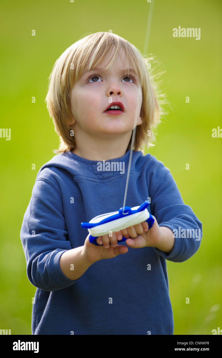 Boy flying kite outdoors Stock Photo - Alamy