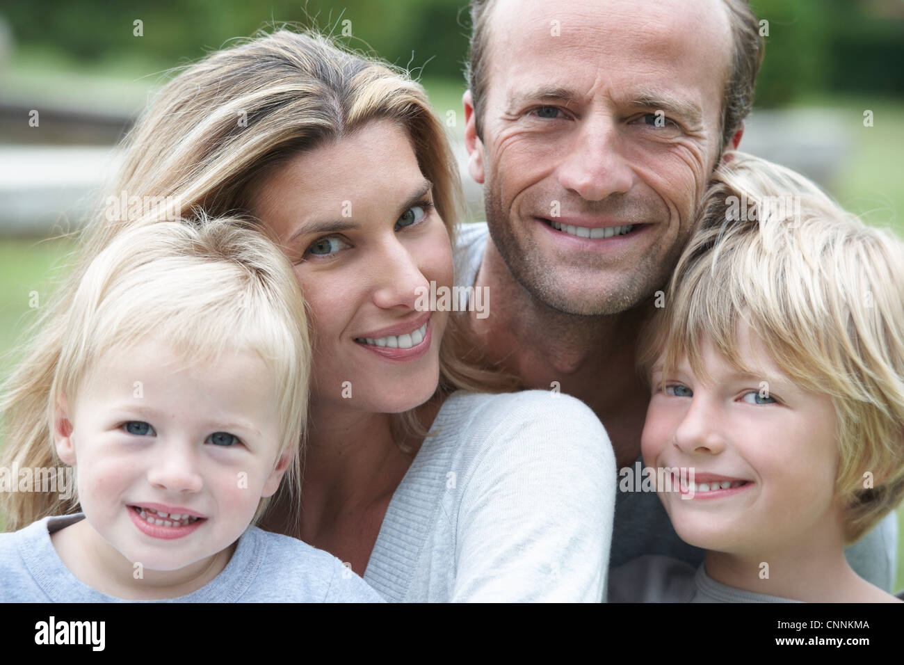 Closeup portrait happy family four hi-res stock photography and images ...