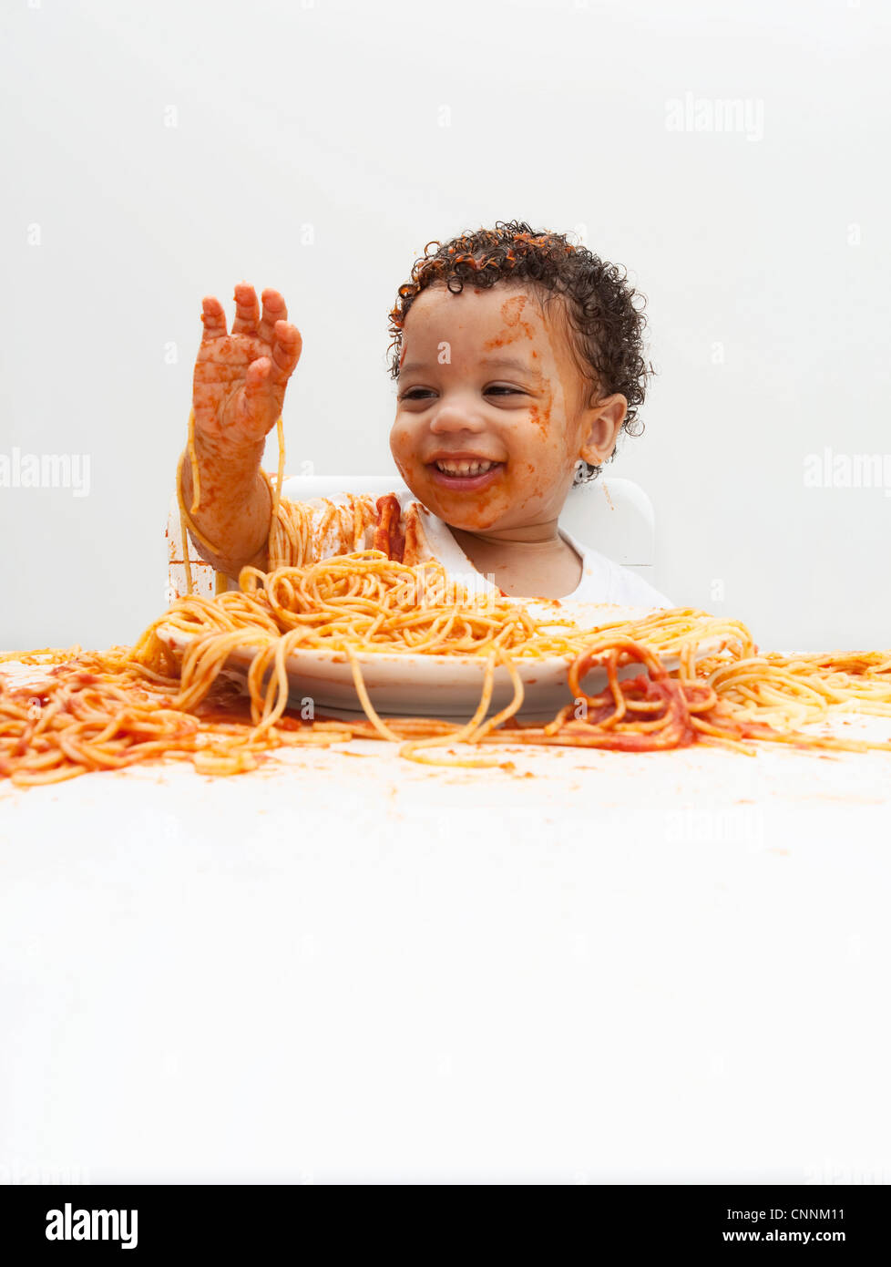 Boy eating Spaghetti with Hands Stock Photo - Alamy