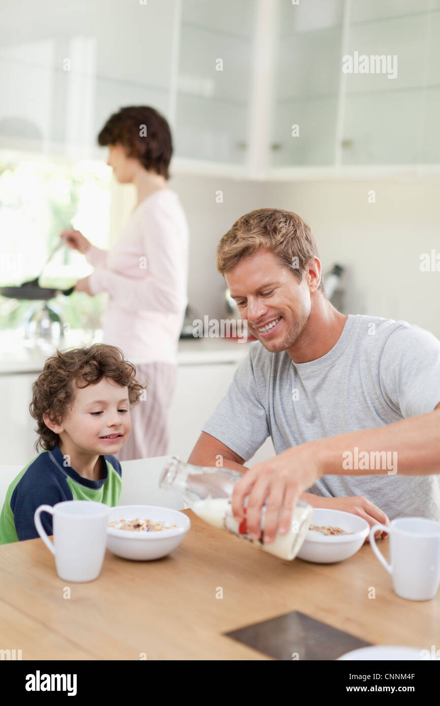 Family eating breakfast in kitchen Stock Photo - Alamy