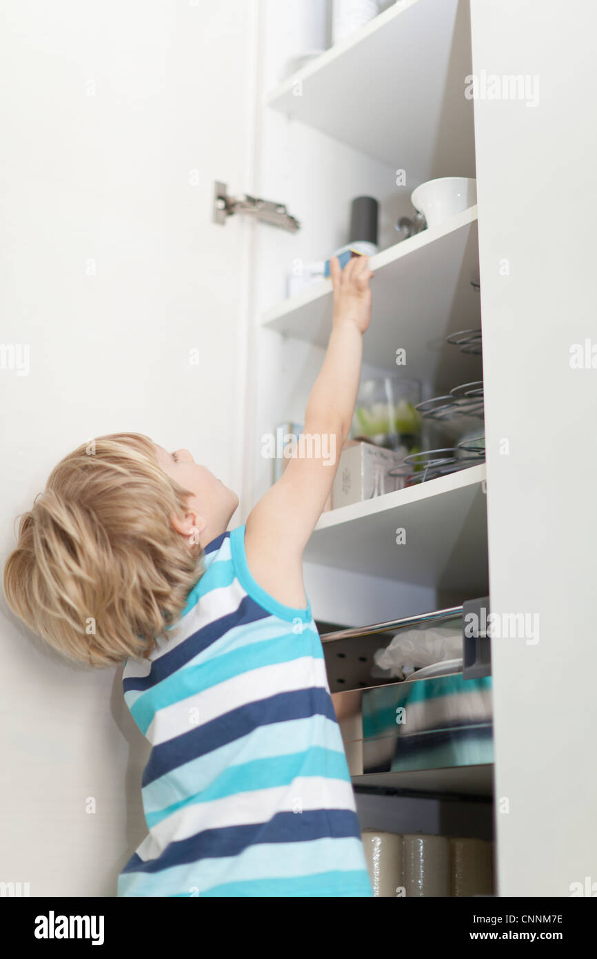 Reaching into cupboard hi-res stock photography and images - Alamy