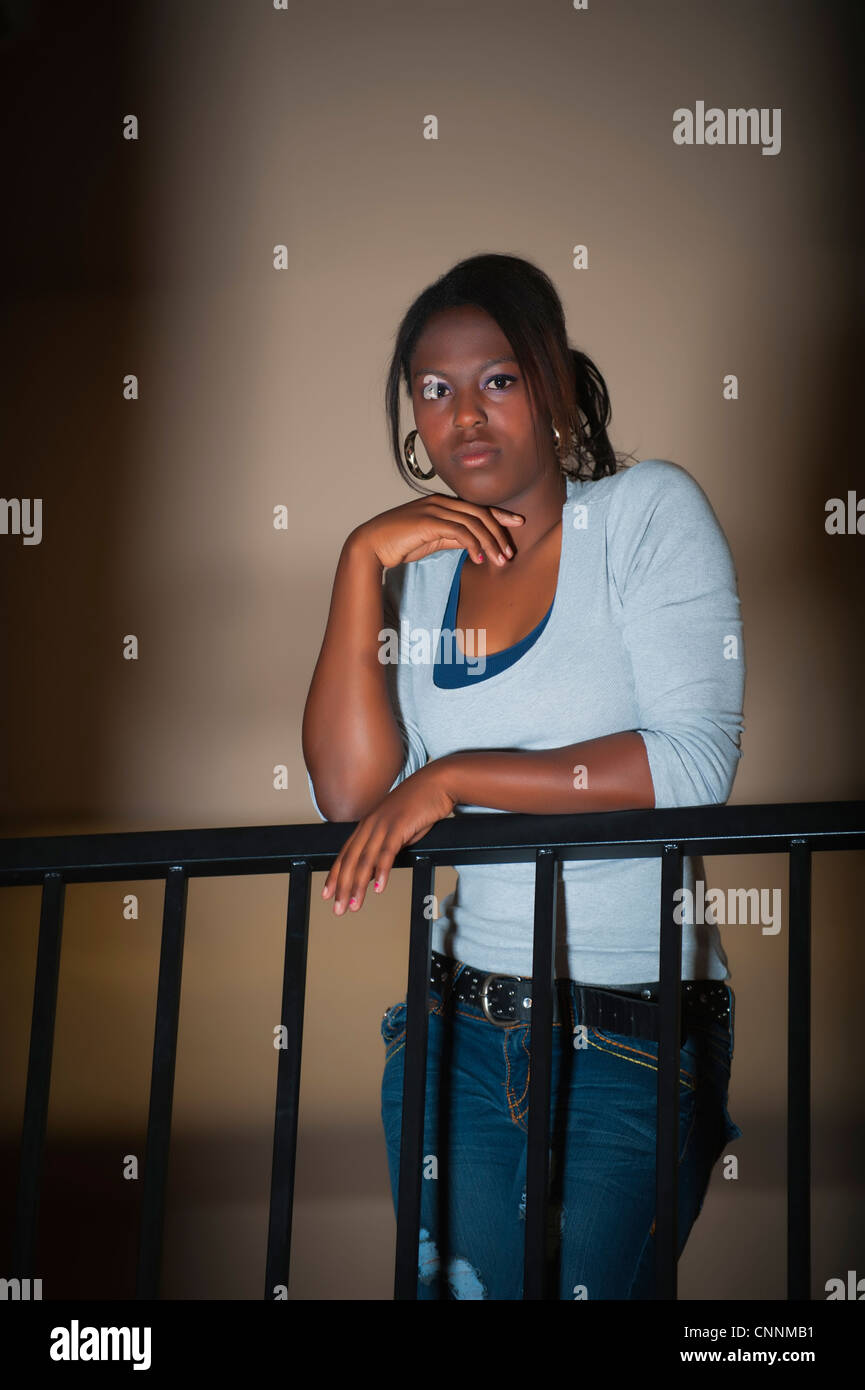 Portrait of young african american woman looking concerned while ...