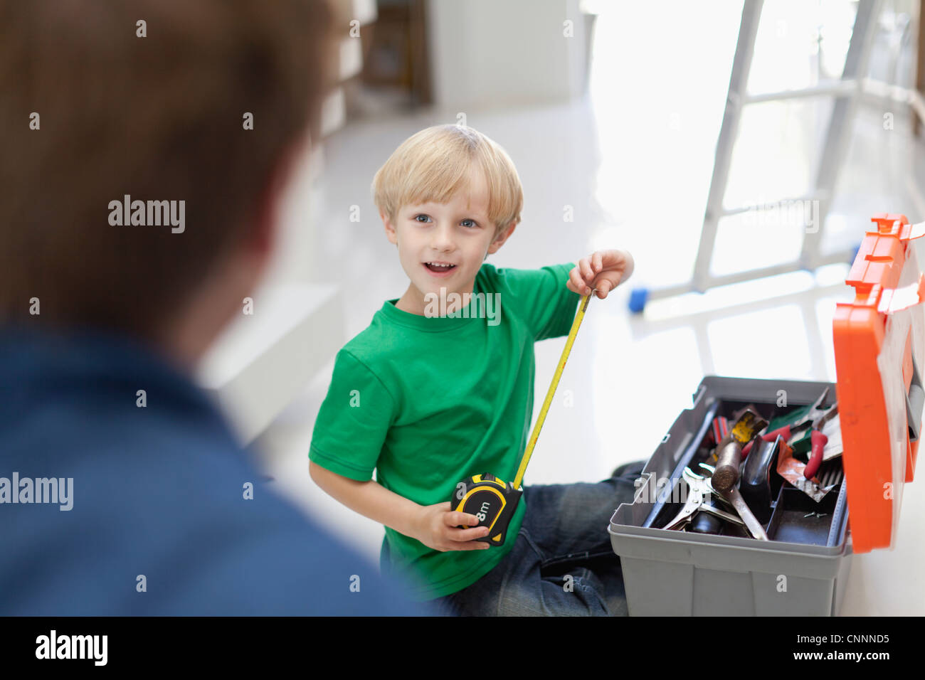Boy with measuring tape and toolbox Stock Photo - Alamy