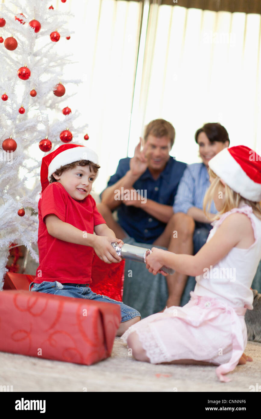Children opening Christmas cracker Stock Photo - Alamy