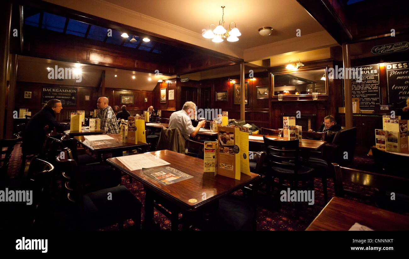 Pub punters at interior tables, London, England, UK Stock Photo - Alamy
