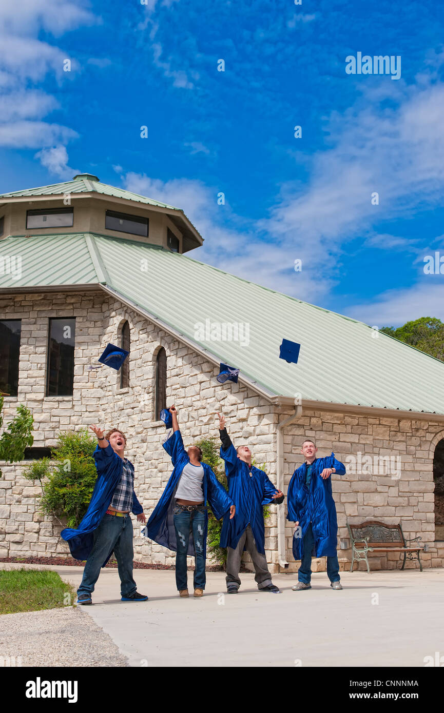 Group of highschool students celebrating their graduation by jumping ...