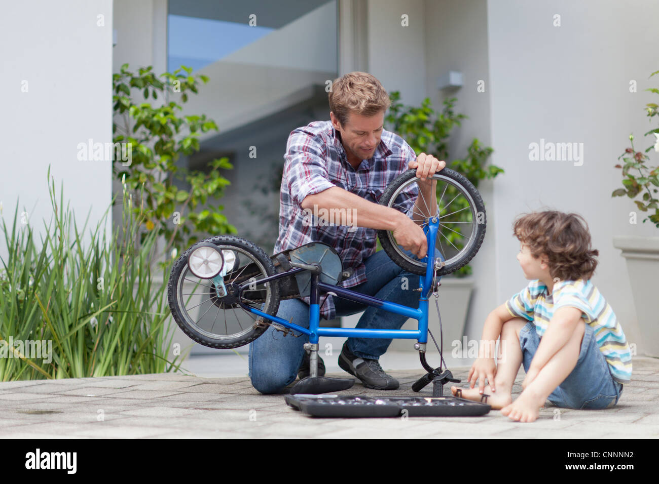 Father Helping Son Fix Bicycle High Resolution Stock Photography and ...
