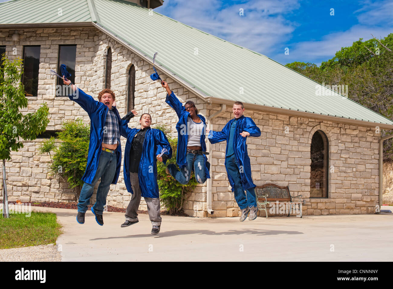 Group of highschool students celebrating their graduation by jumping ...