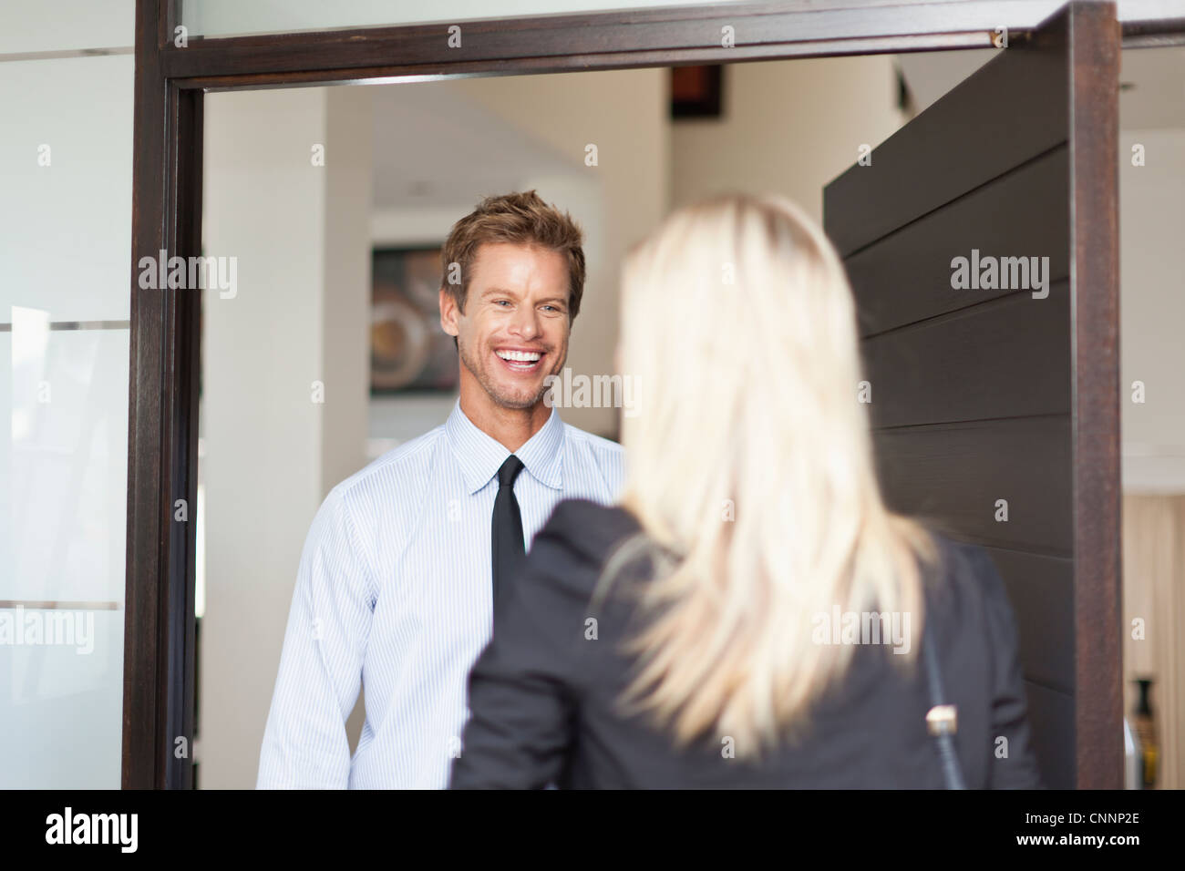 Business people smiling at each other Stock Photo - Alamy