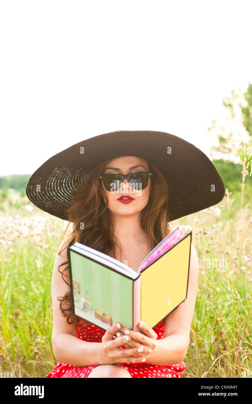 Woman Reading Book in Field Stock Photo - Alamy