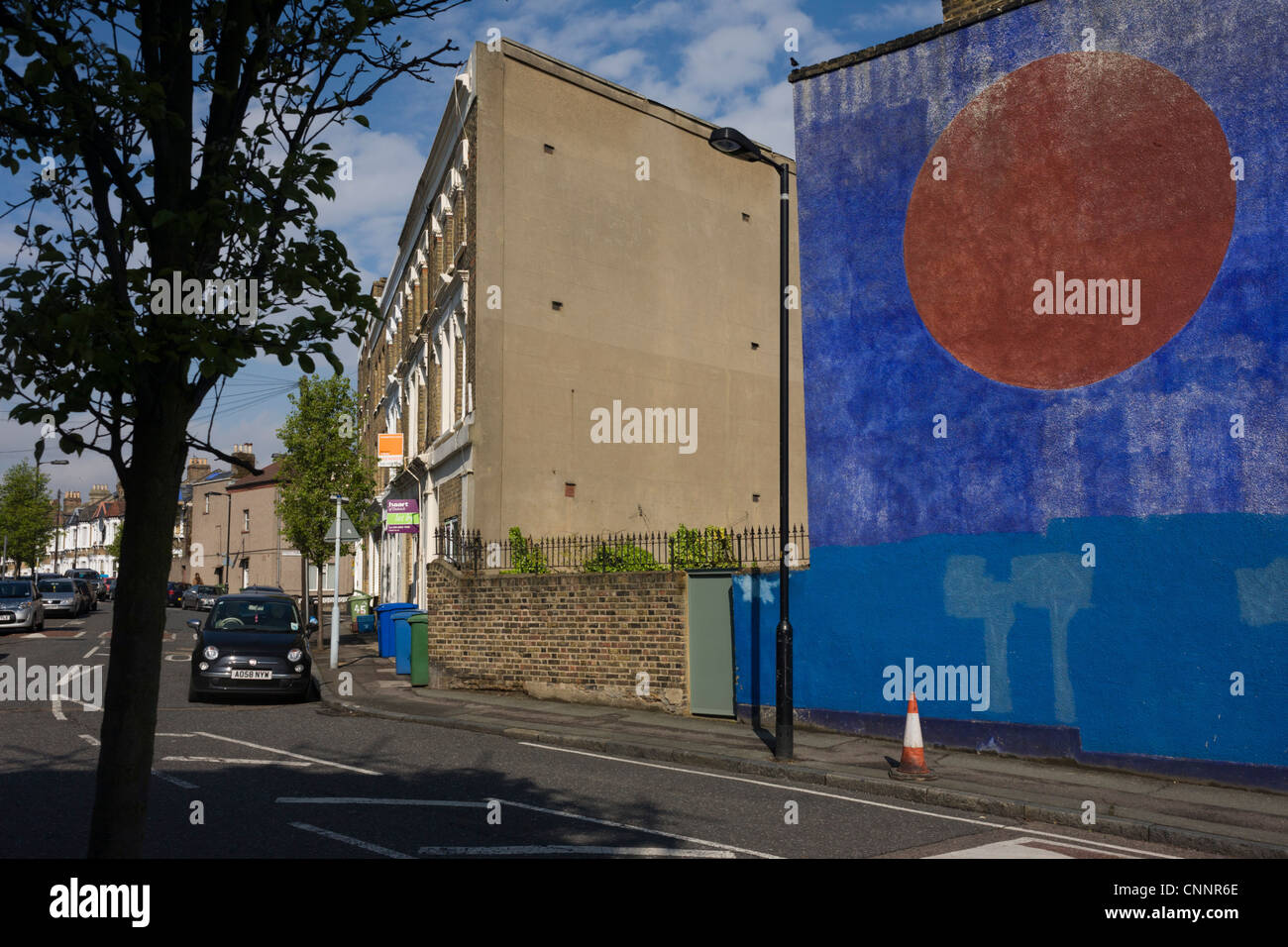 Giant circle painted on the side wall of a Victorian terraced home in a ...