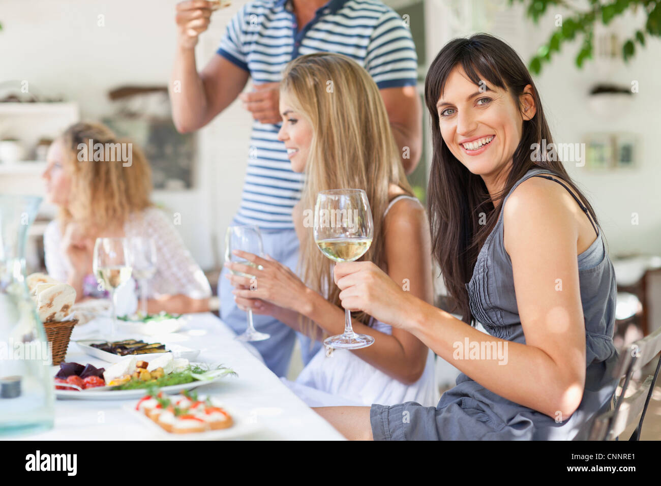 Friends eating at table outdoors Stock Photo - Alamy