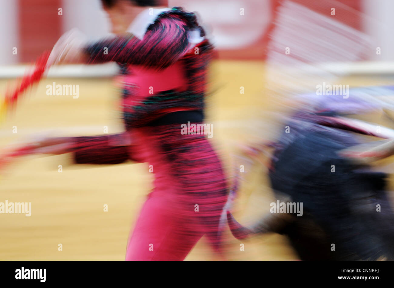 Bullfighting Banderillero escaping bull in bullring blurred movement ...