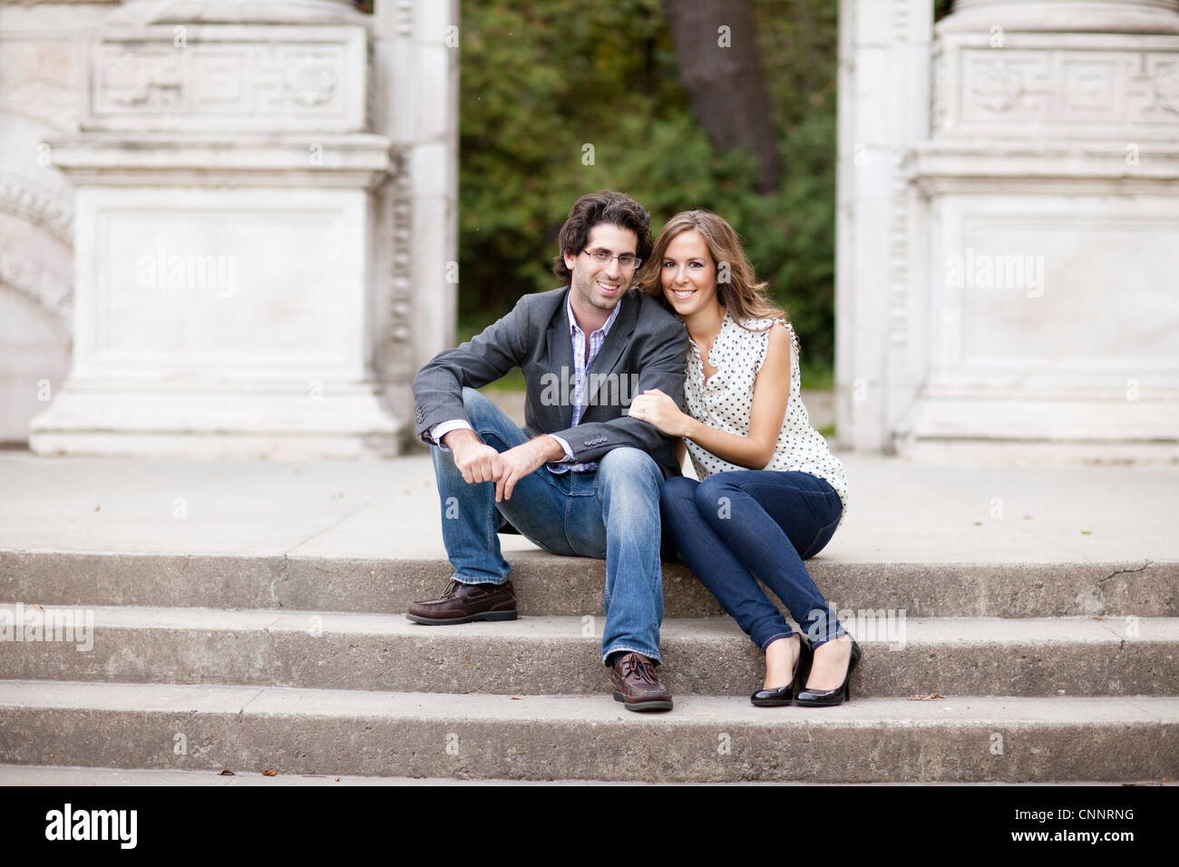 Portrait of Young Couple Sitting on Stairs in Park, Ontario, Canada ...