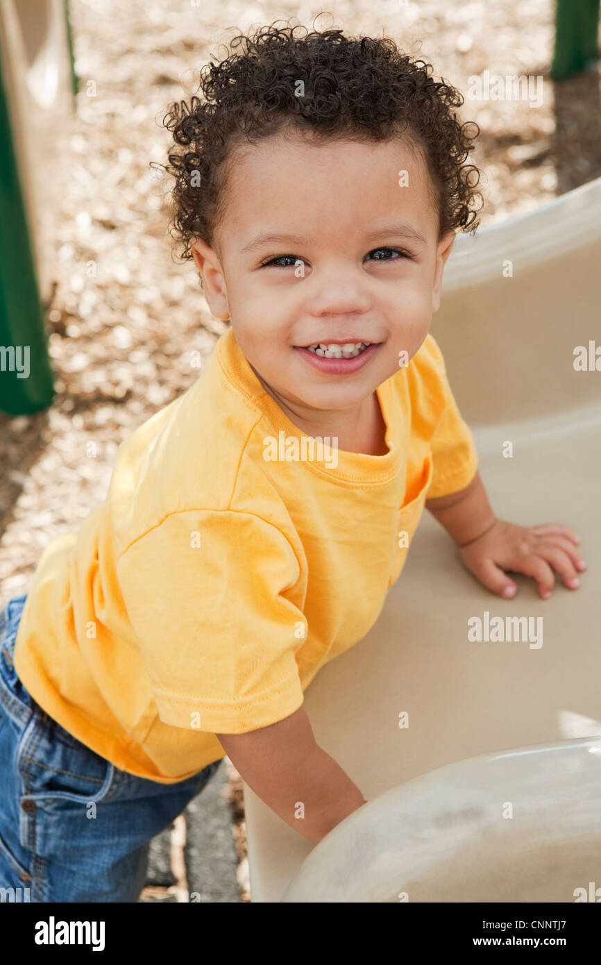 Portrait of Young Boy Standing at Bottom of Slide at Playground Stock ...