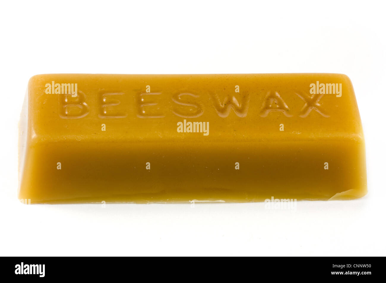 Stick of beeswax over white Stock Photo - Alamy
