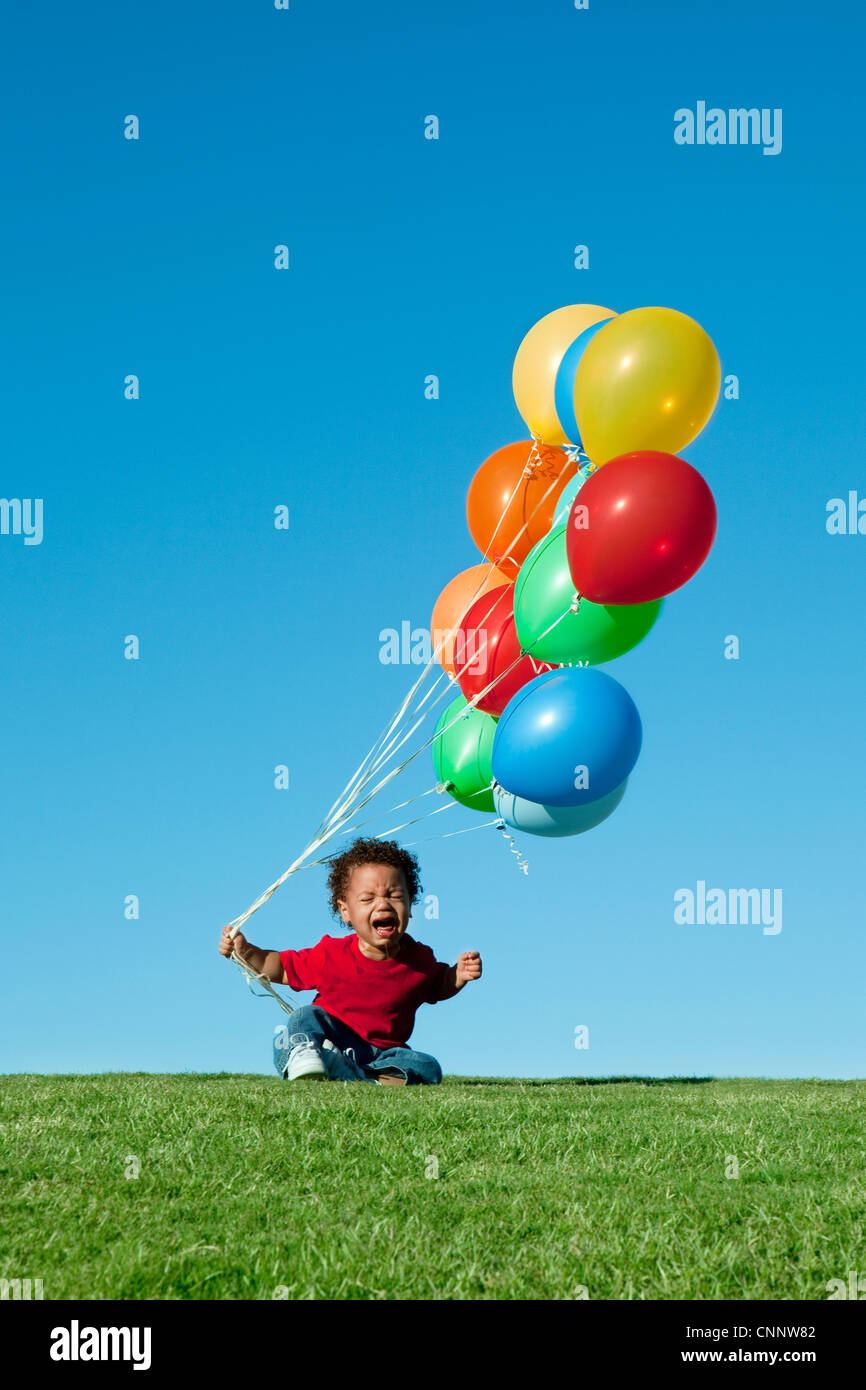 Crying Boy with Balloons Stock Photo - Alamy