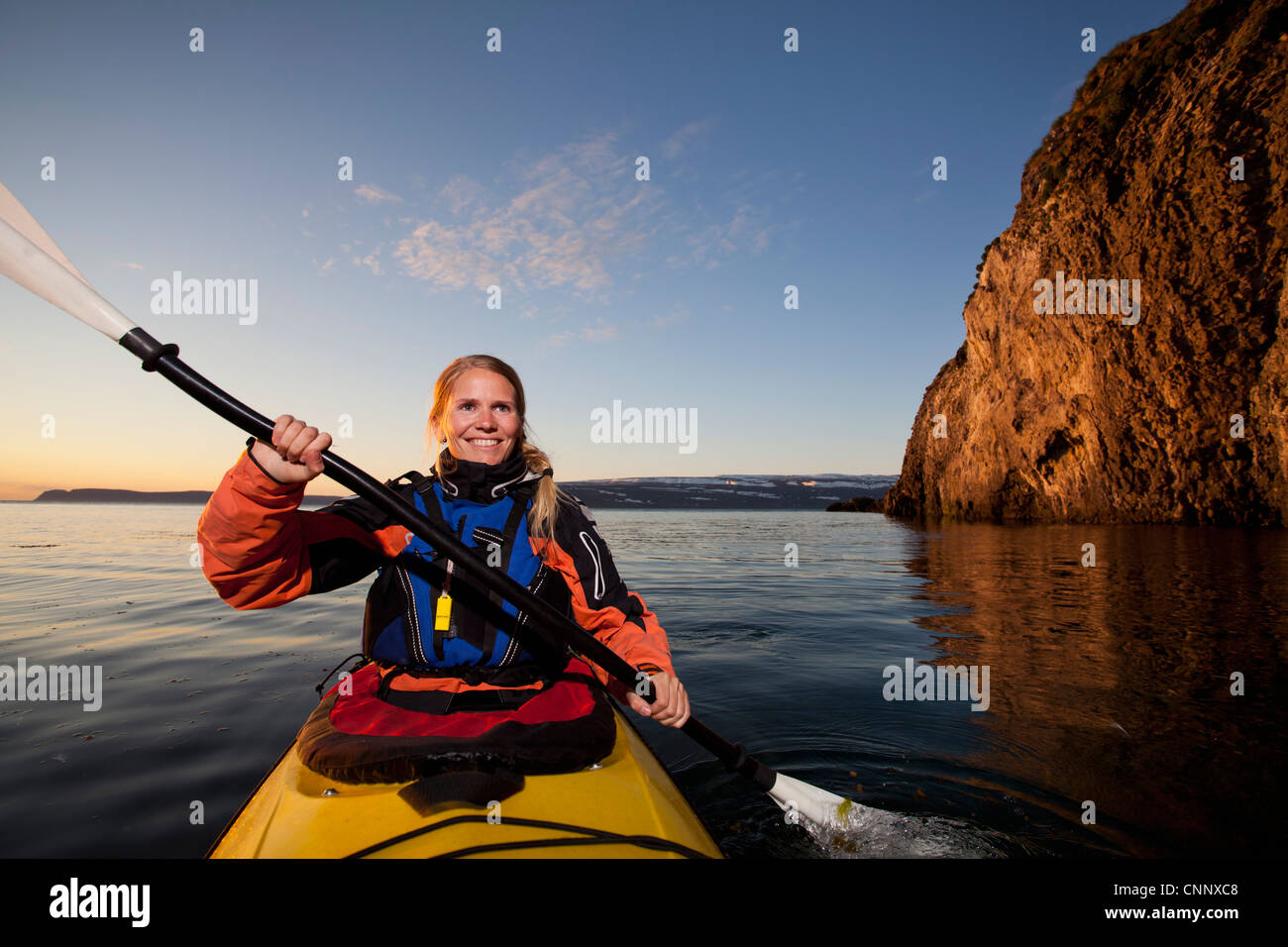 Woman kayaking in still lake Stock Photo - Alamy