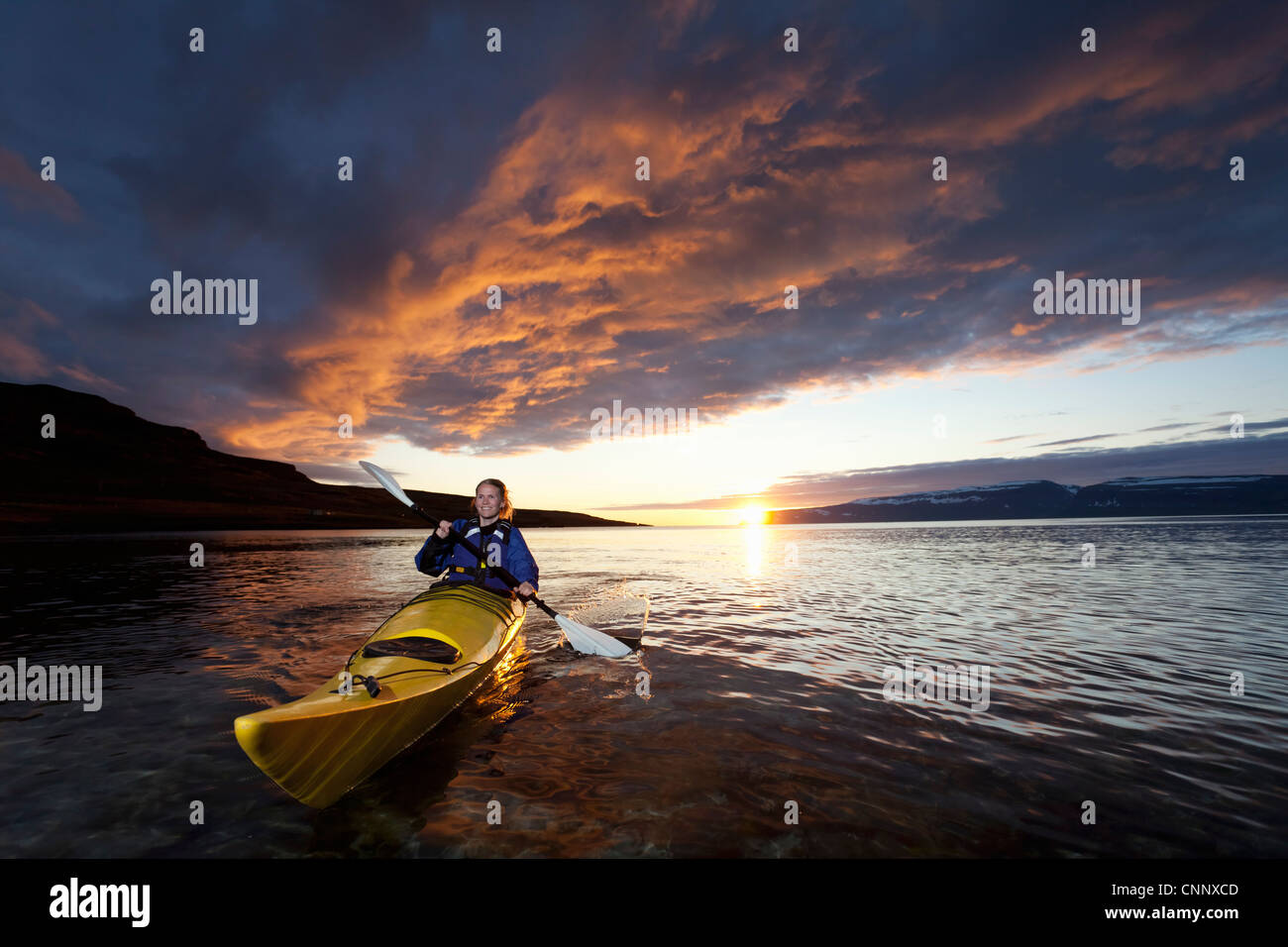 Woman kayaking in still lake Stock Photo - Alamy