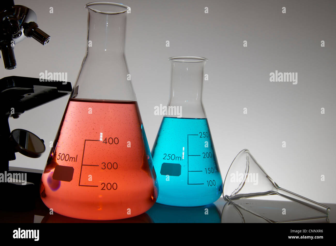 research microscope and laboratory bottles with colored liquid Stock ...