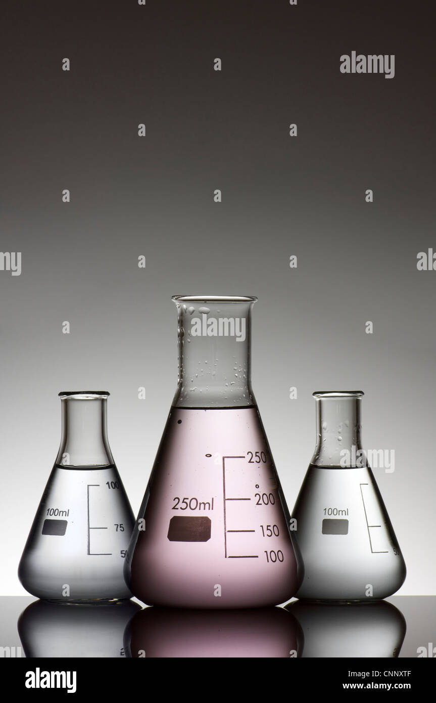 three laboratory flasks with liquid and a white background Stock Photo ...