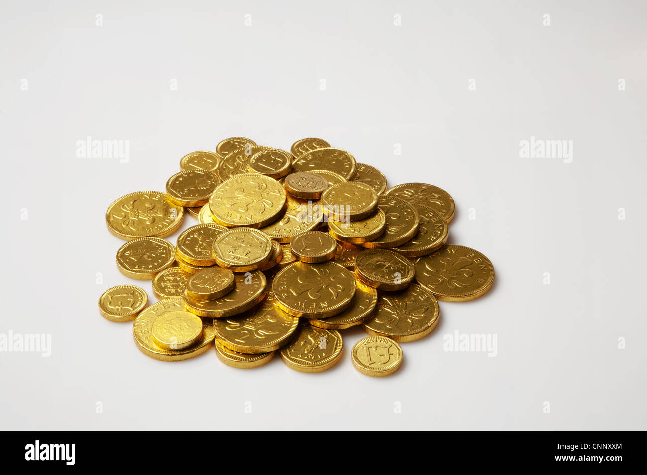 chocolate money coins on white background Stock Photo - Alamy