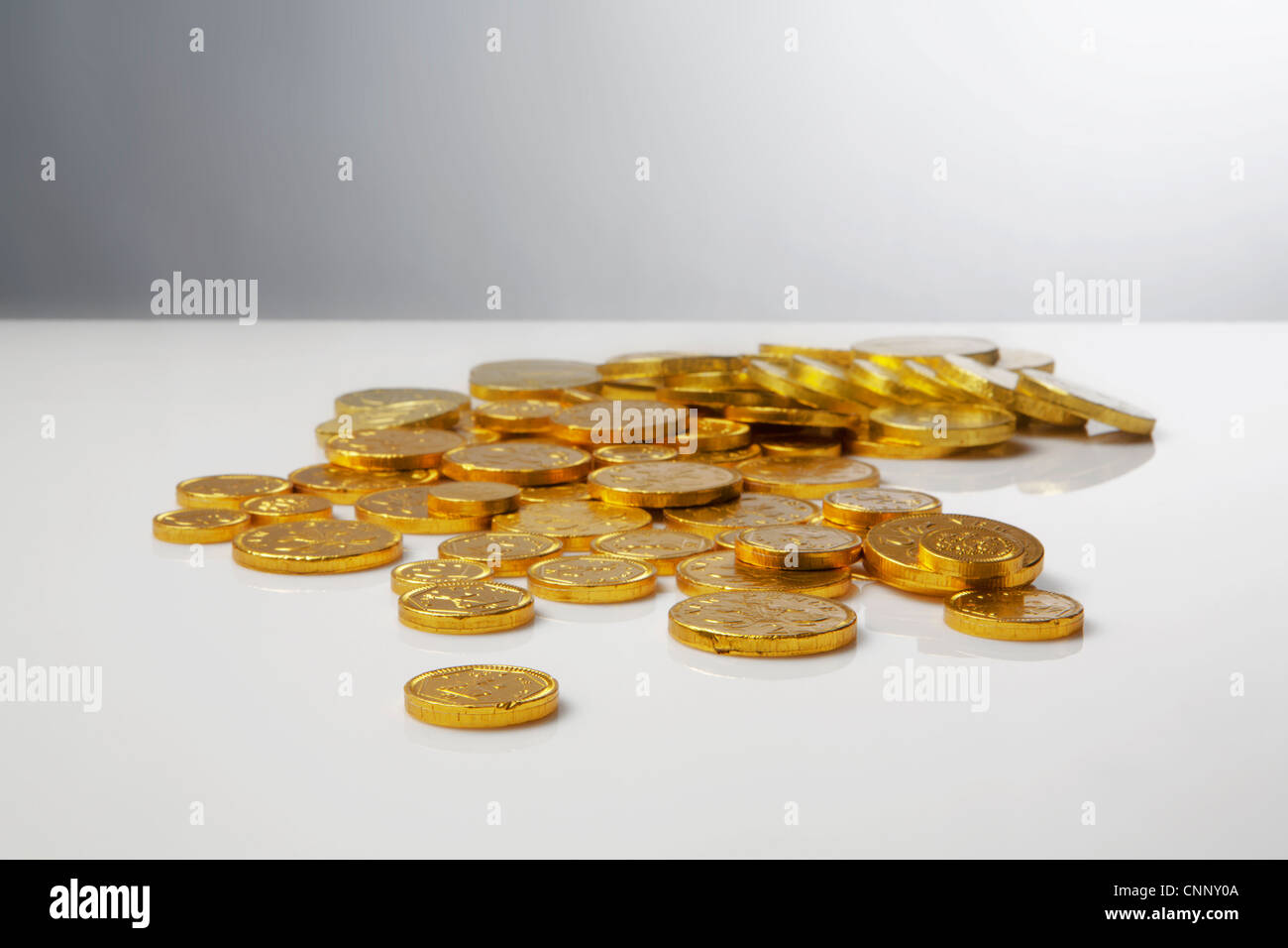chocolate money coins on white background Stock Photo - Alamy