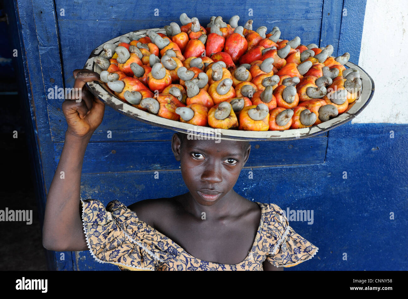 africa SIERRA LEONE Tombo, market, young girl carry a plate with cashew ...