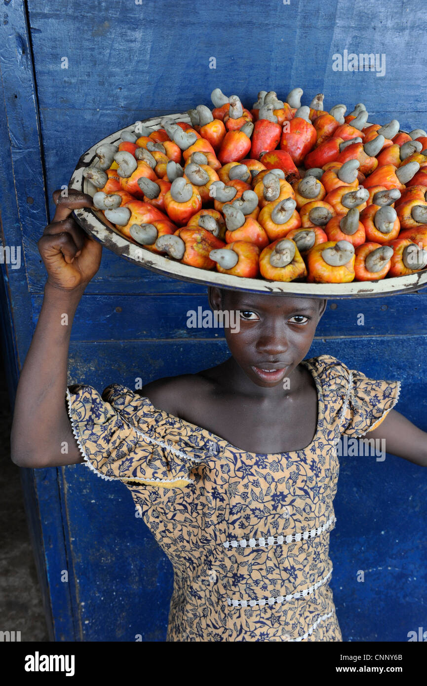 africa SIERRA LEONE Tombo, market, young girl carry a plate with cashew ...