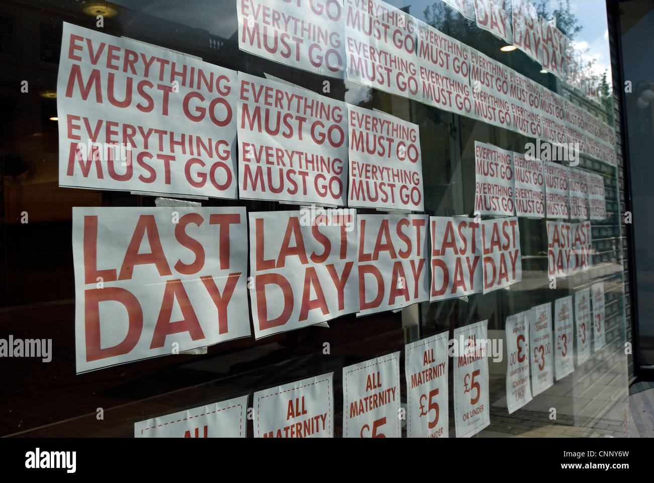 everything must go, last days of sale stickers in shop window in ...