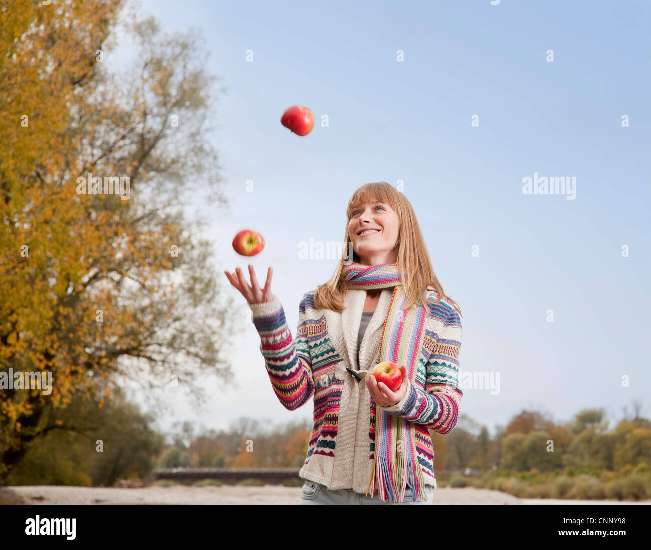 Woman juggling apples outdoors Stock Photo - Alamy