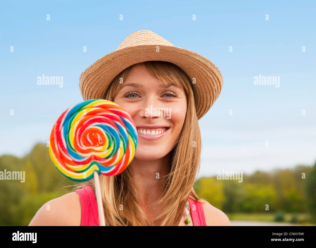 Woman eating lollipop outdoors Stock Photo - Alamy
