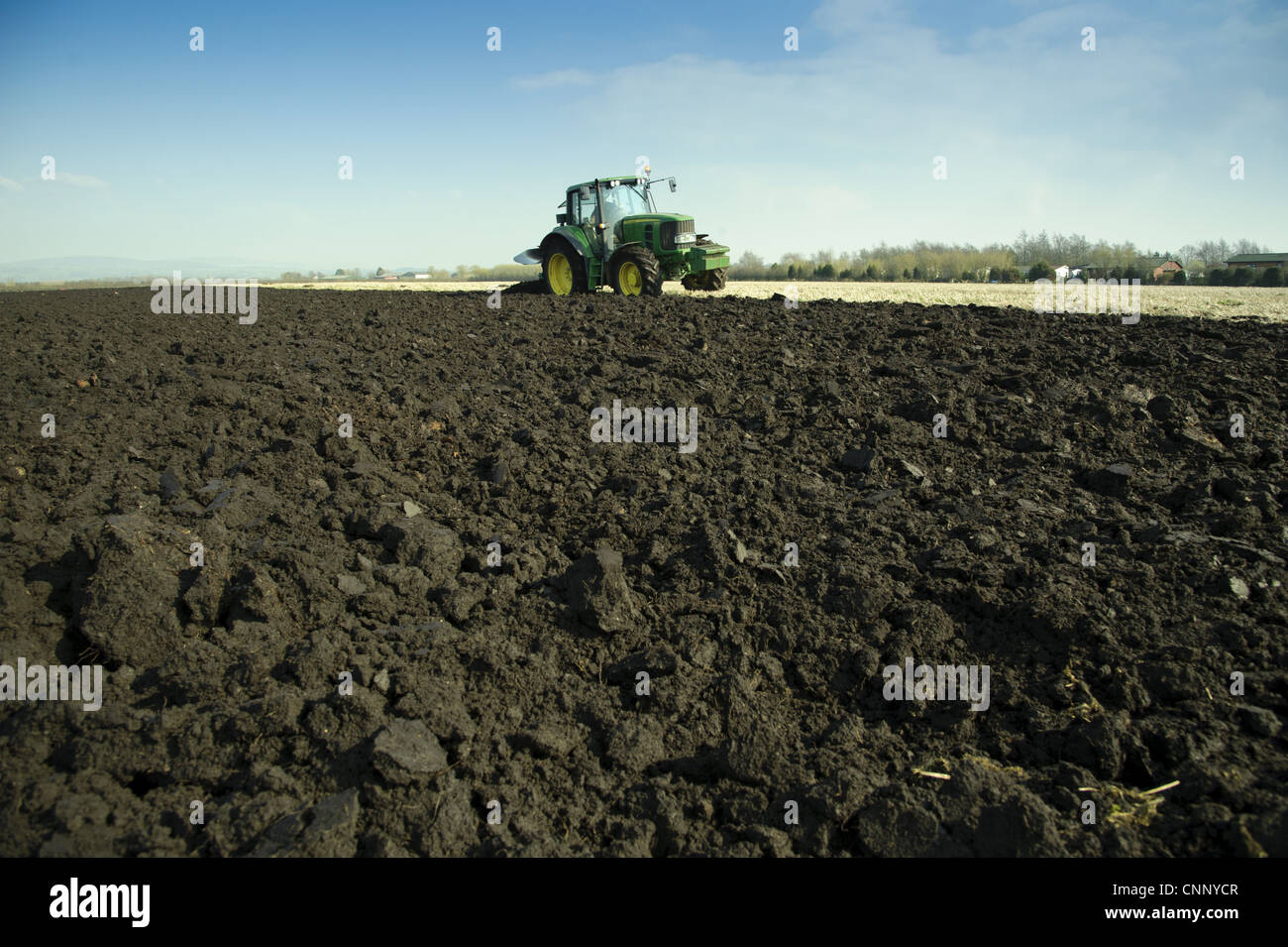 Tractor with plough, ploughing arable field, Pilling, Lancashire ...