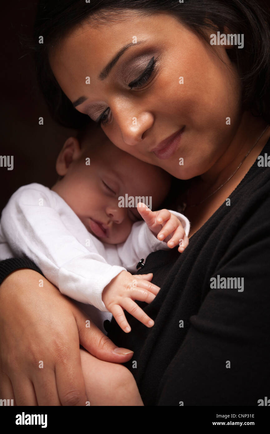 Young Attractive Ethnic Woman Holding Her Newborn Baby Under Dramatic ...