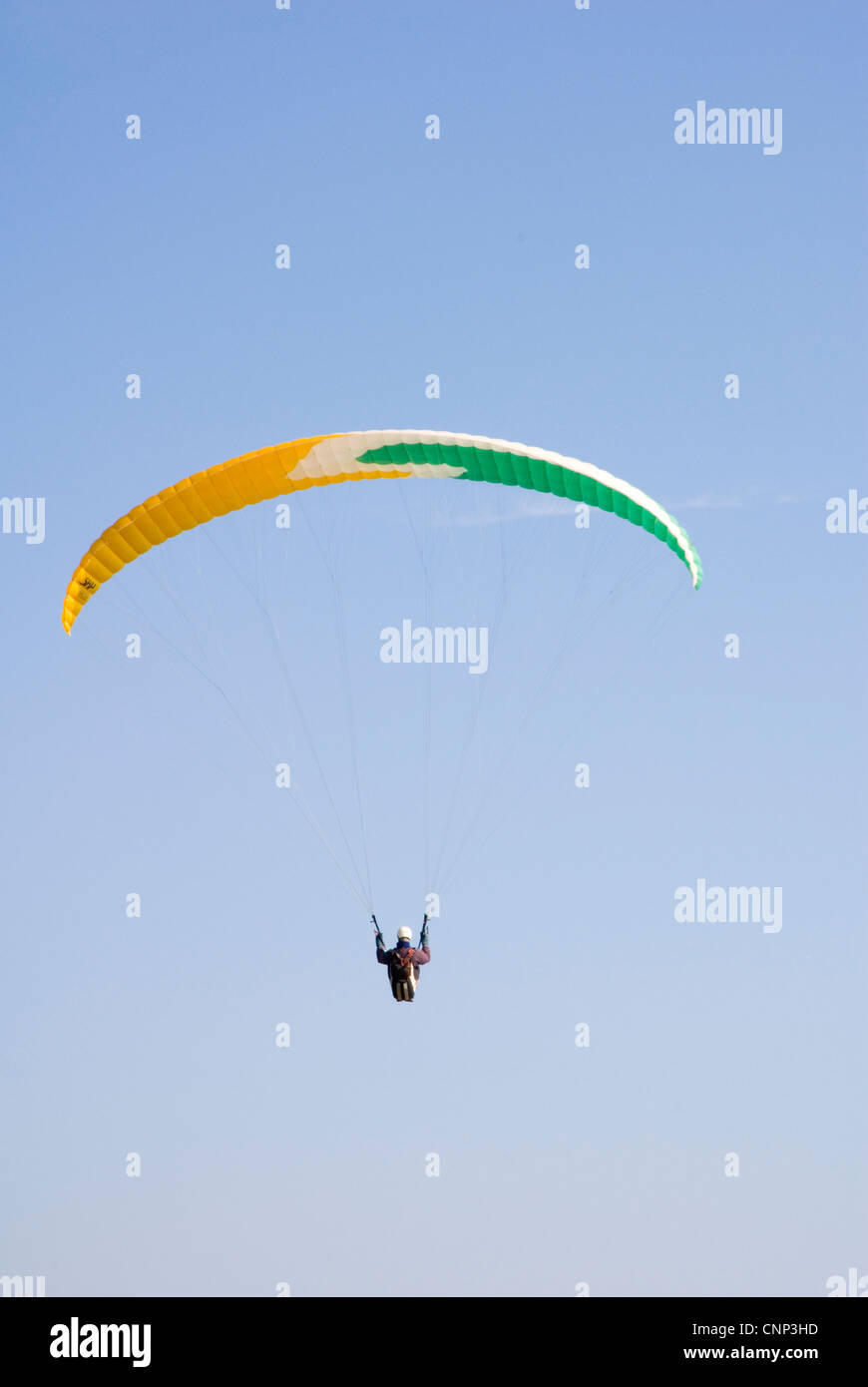 Para glider - blue sky - yellow green and white canopy above - floating ...